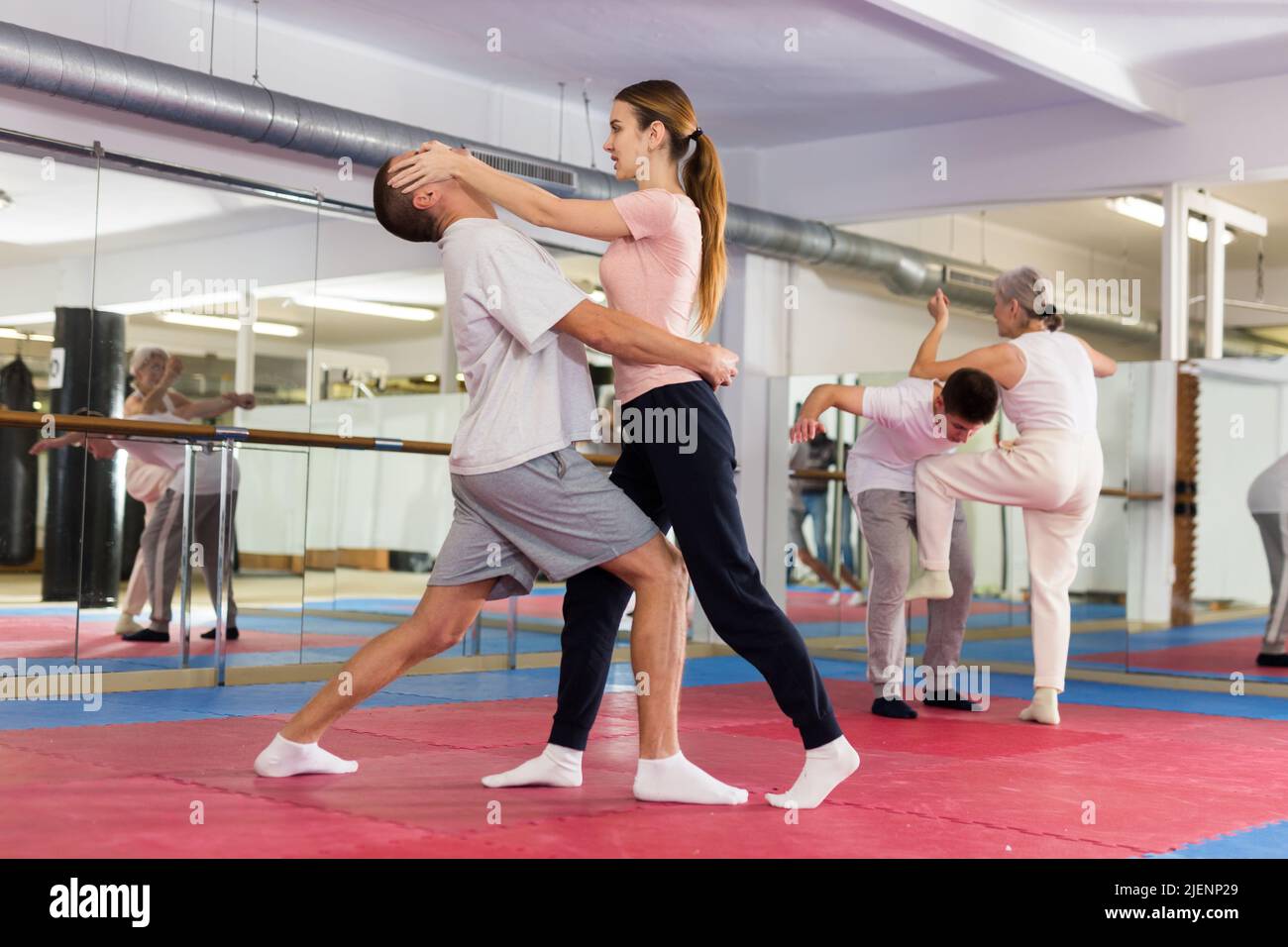 Woman performing eye-gouging move during self-defence training Stock ...