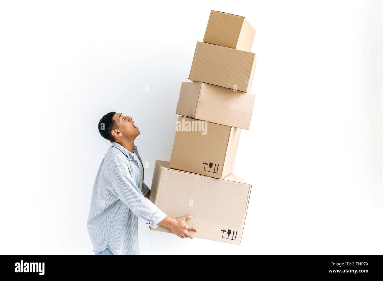 Delivery concept. Frightened mixed race delivery man, looking excitedly ...