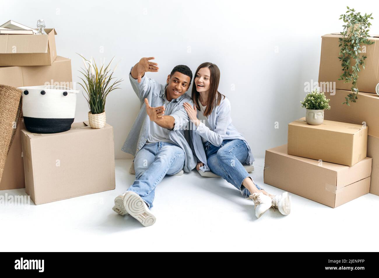 The moving, new housing. Happy young multiracial couple, caucasian ...