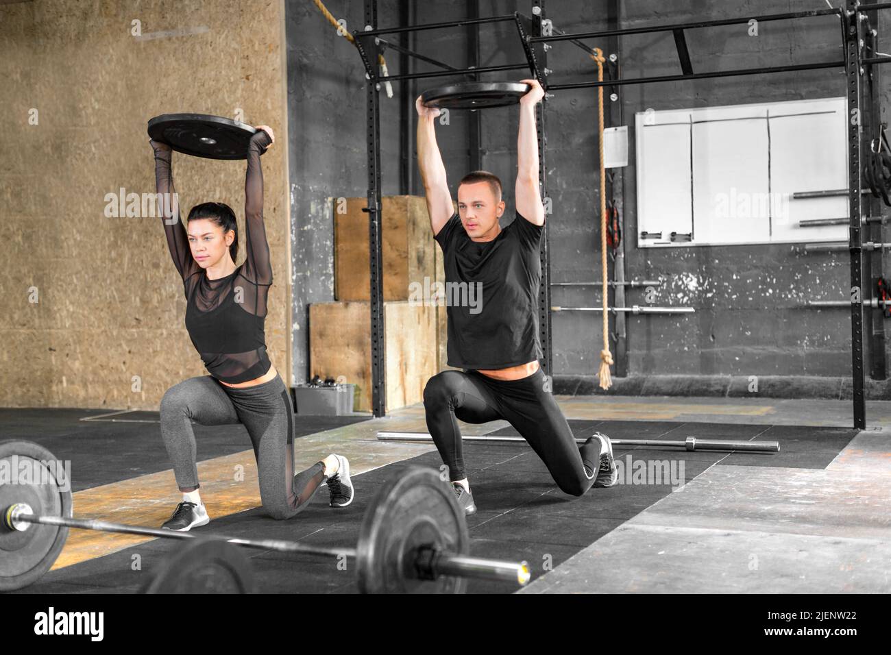 Fitness couple in gym working out together. Teamwork and healthy ...