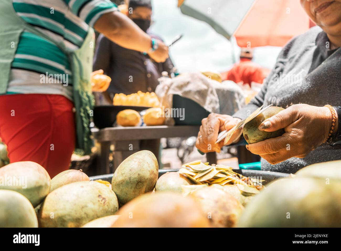 Woman hands peeling mango hi-res stock photography and images - Alamy