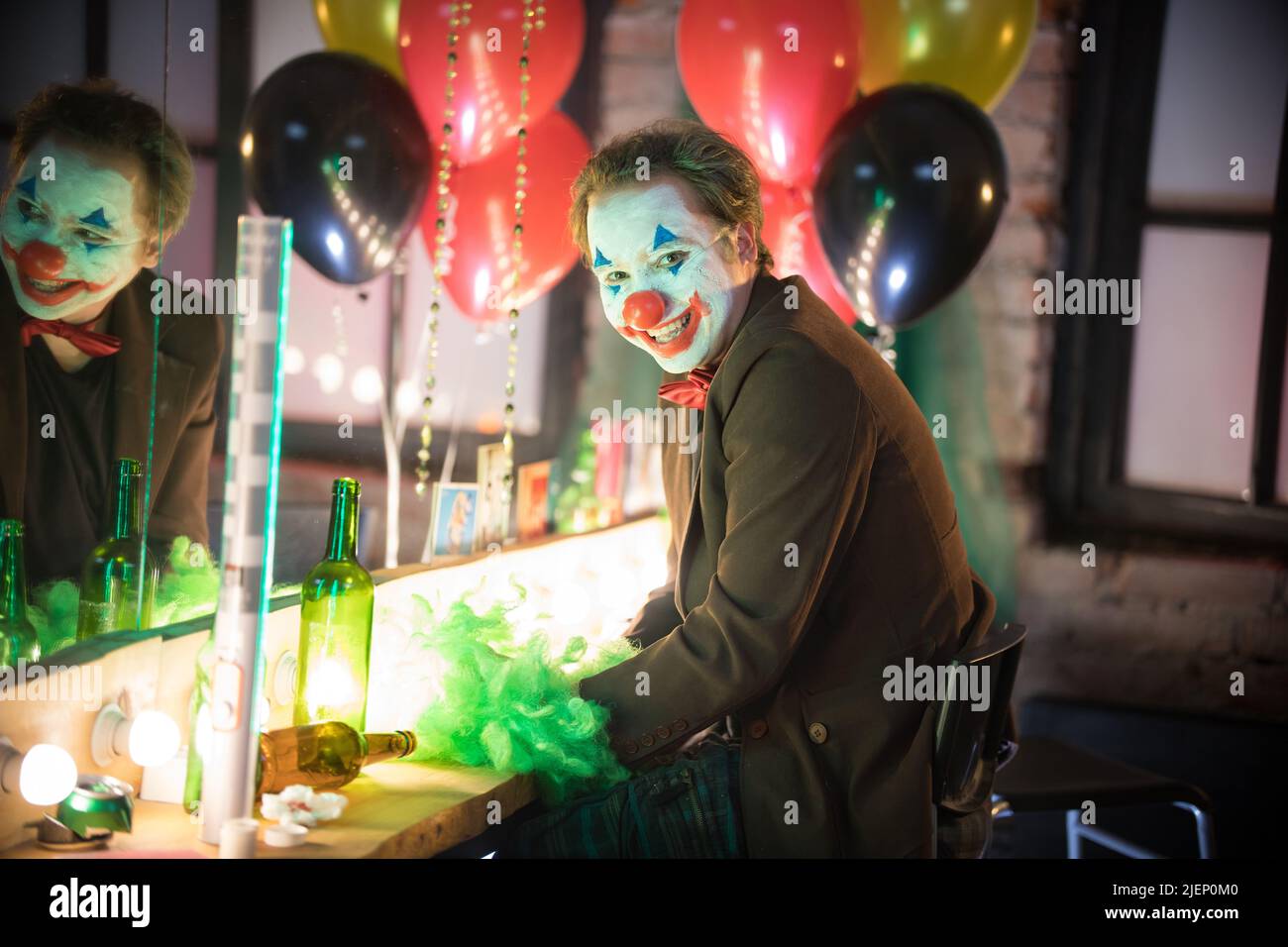 Clown concept - a crazy man clown looking in the camera and smiling ...