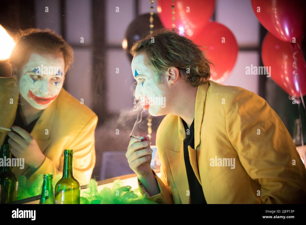 Clown concept - a tired man clown in yellow jacket smoking in the ...