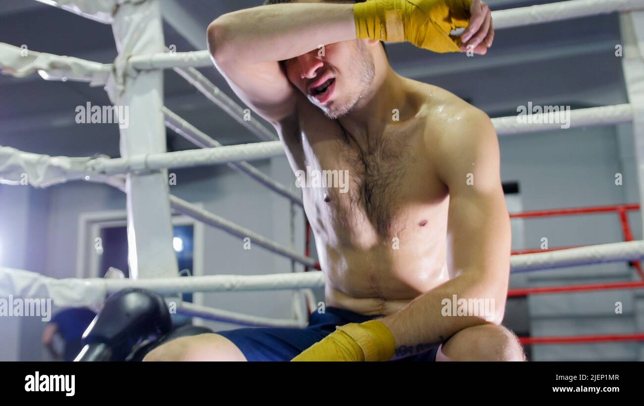 BOX - boxer is wiping sweat from his face with his hand Stock Photo - Alamy