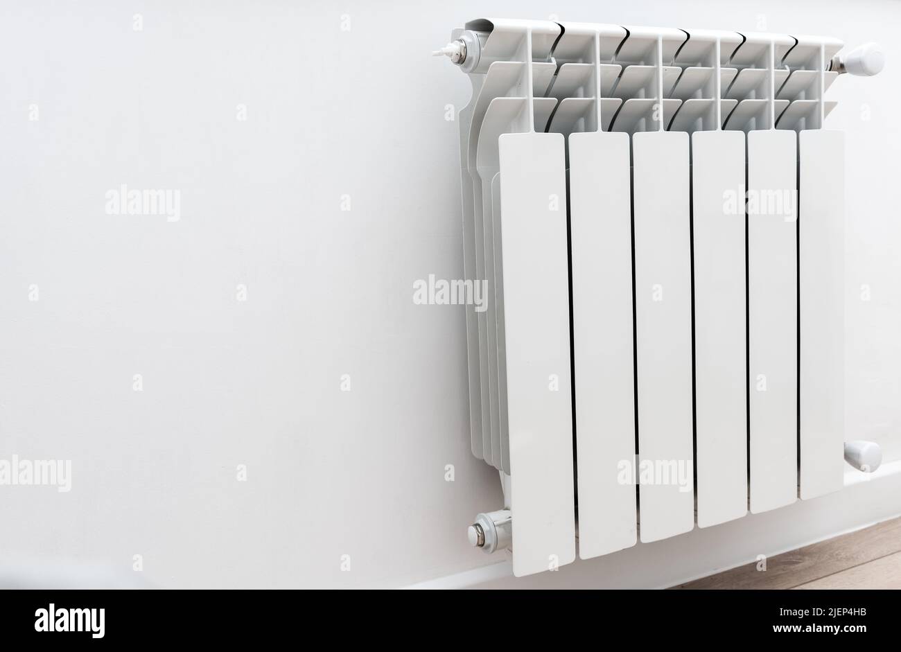 Heating radiator sections on the wall Stock Photo - Alamy