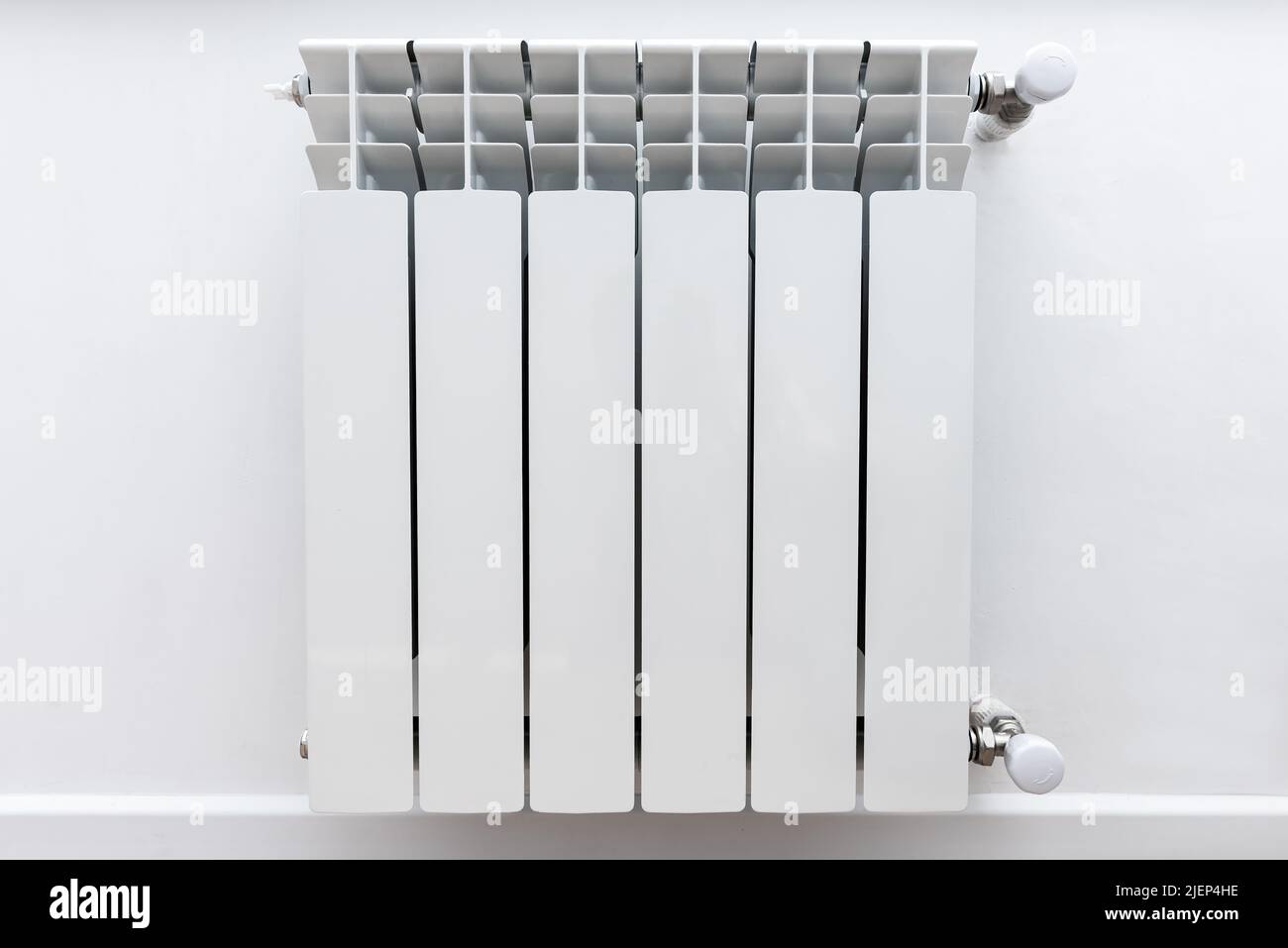 Heating radiator sections on the wall Stock Photo - Alamy