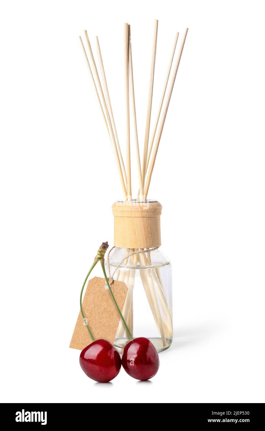 Reed diffuser and cherry on white background Stock Photo - Alamy