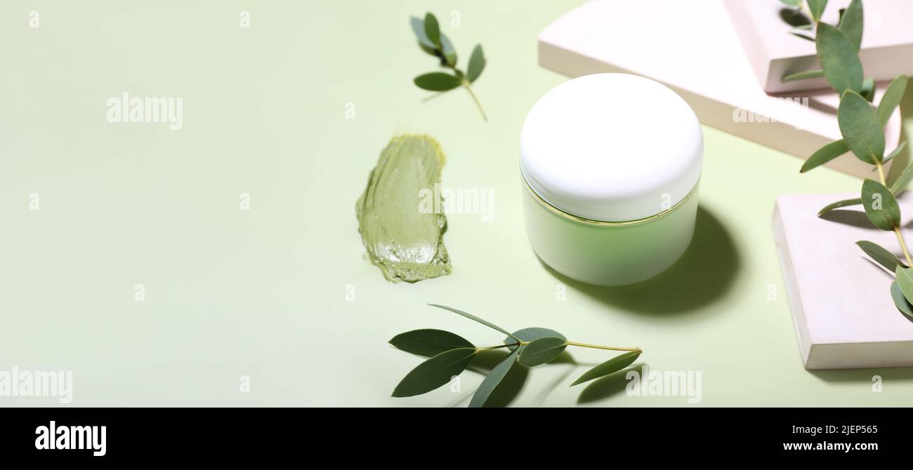 Jar of cosmetic clay on green background with space for text Stock ...