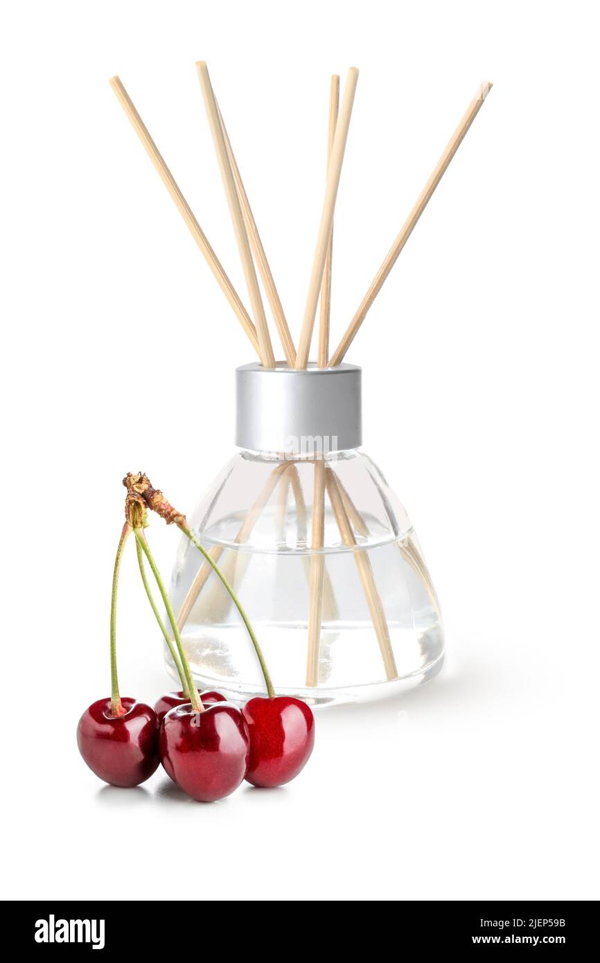 Reed diffuser and cherry on white background Stock Photo - Alamy