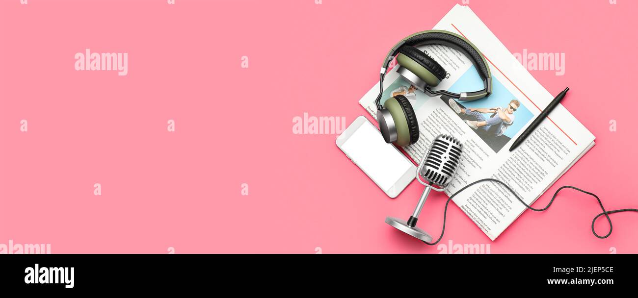 Headphones with microphone, mobile phone and newspaper on pink ...