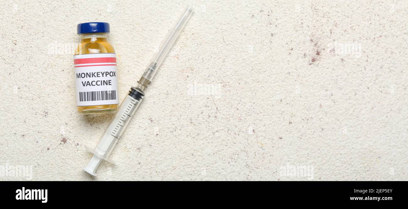 Ampule of monkeypox vaccine and syringe on light background Stock Photo ...