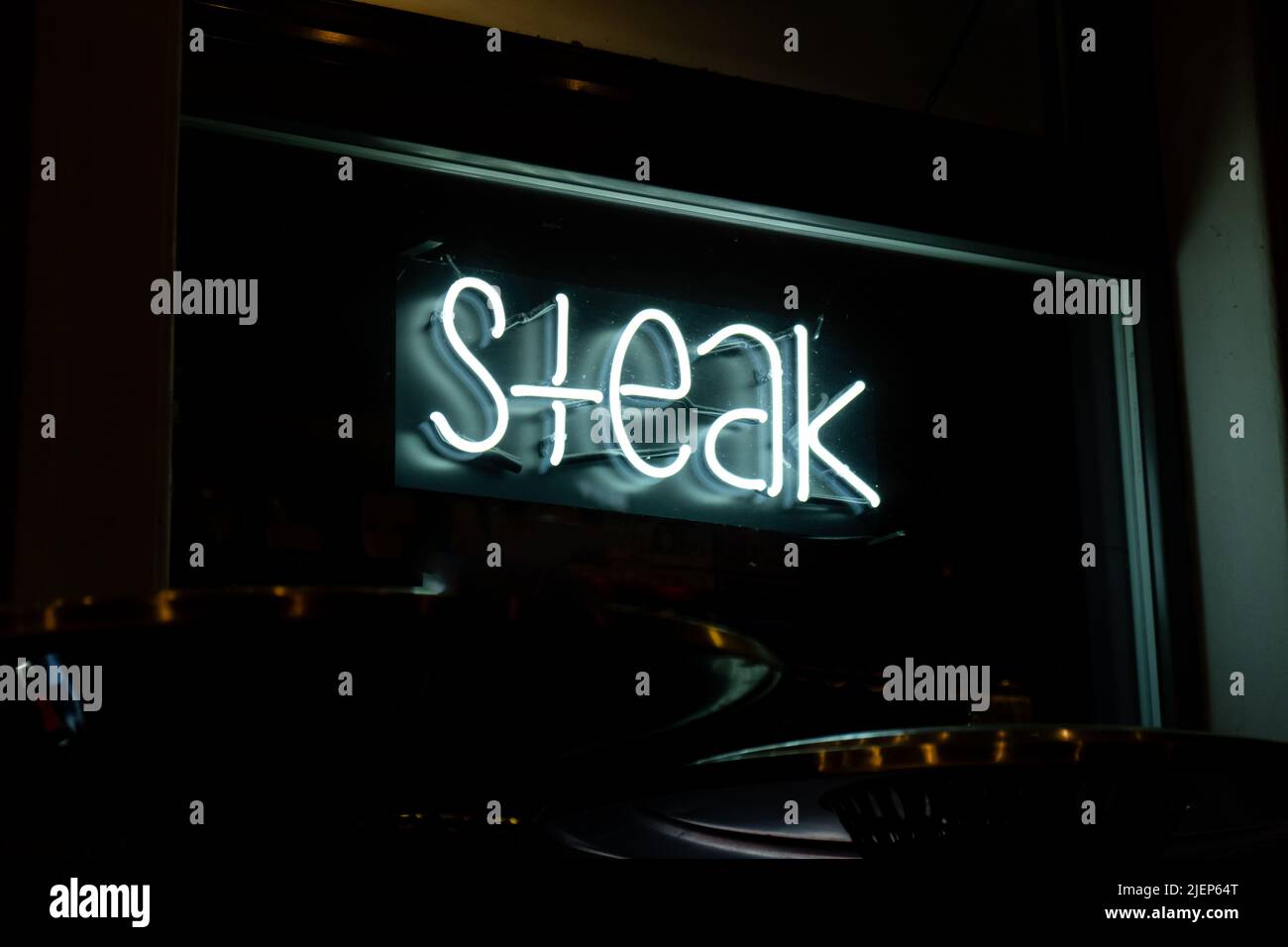 Steak inscription in neon lights at night. Electric sign at night ...