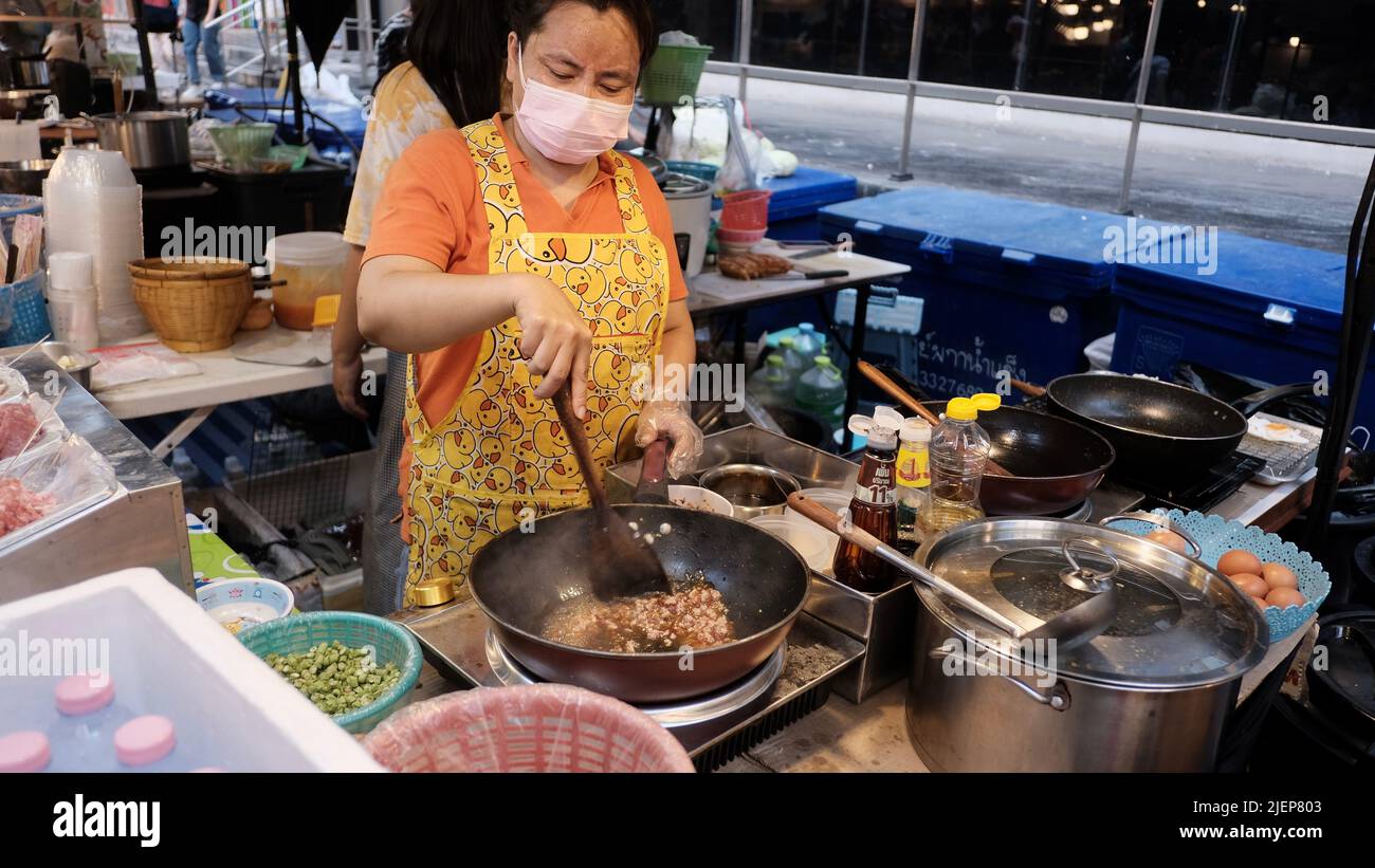 Chef wearing a mask cooking hot foodevent Stock Photo - Alamy
