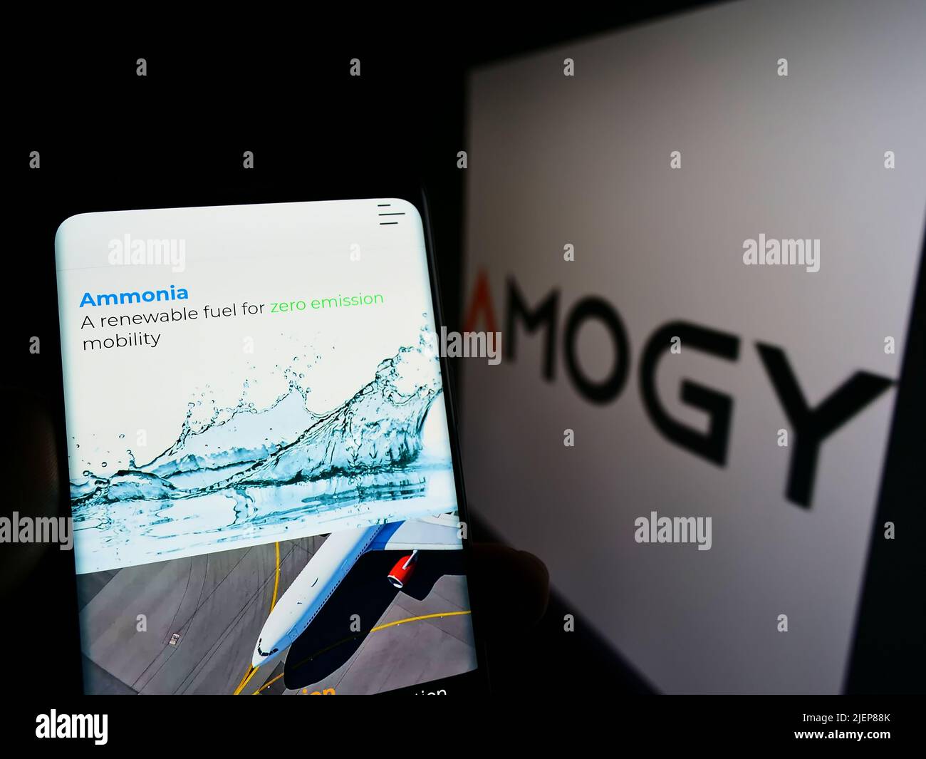 Person holding cellphone with website of US ammonia fuel company Amogy ...