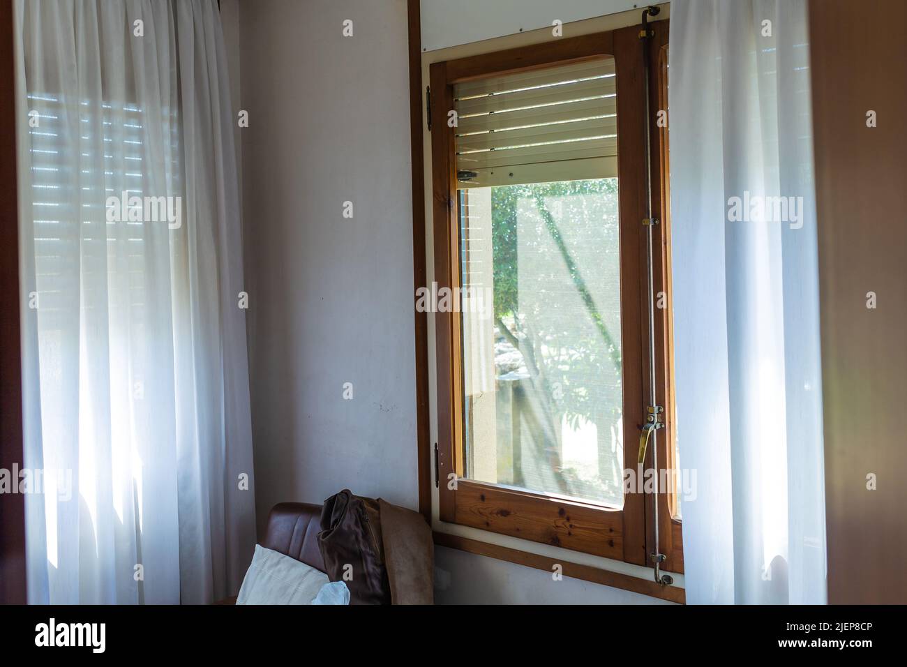 Old Wooden Closed Window With White Curtains On An Interior Scene Stock