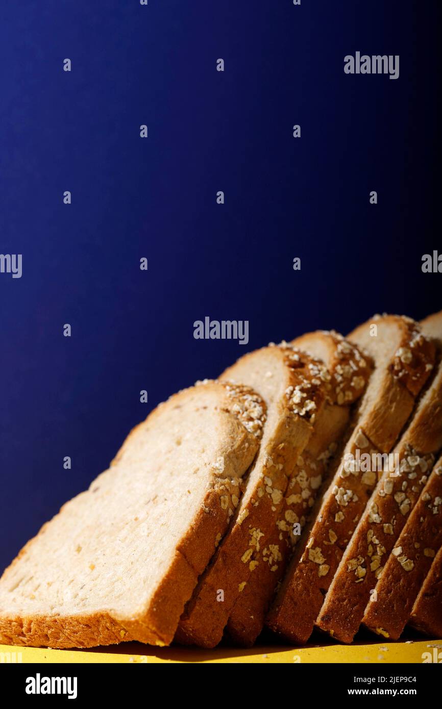 White Bread with Whole Grain Cereal Topping on Blue Background, Copy ...