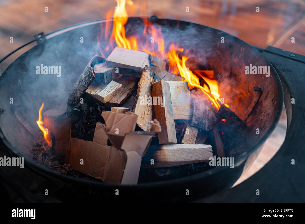 Barbecue grill with fire on open air close up Stock Photo - Alamy