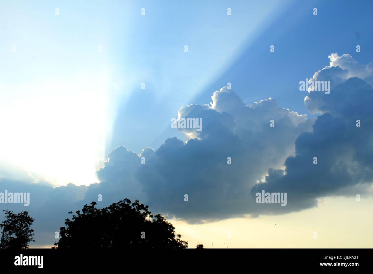 sun rays coming out from clouds Stock Photo - Alamy
