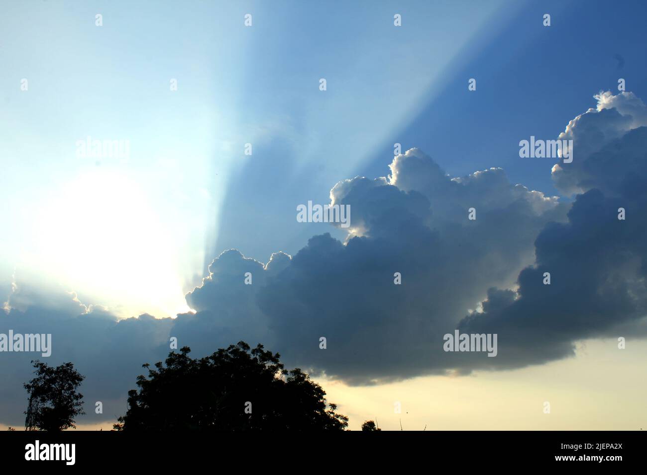 sun rays coming out from clouds Stock Photo - Alamy