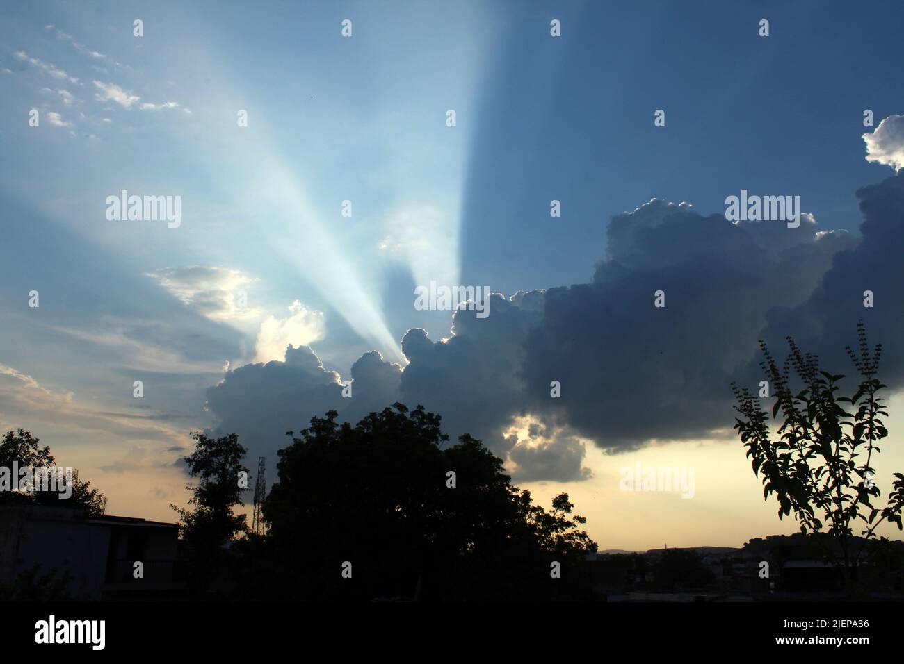 sun rays coming out from clouds Stock Photo - Alamy