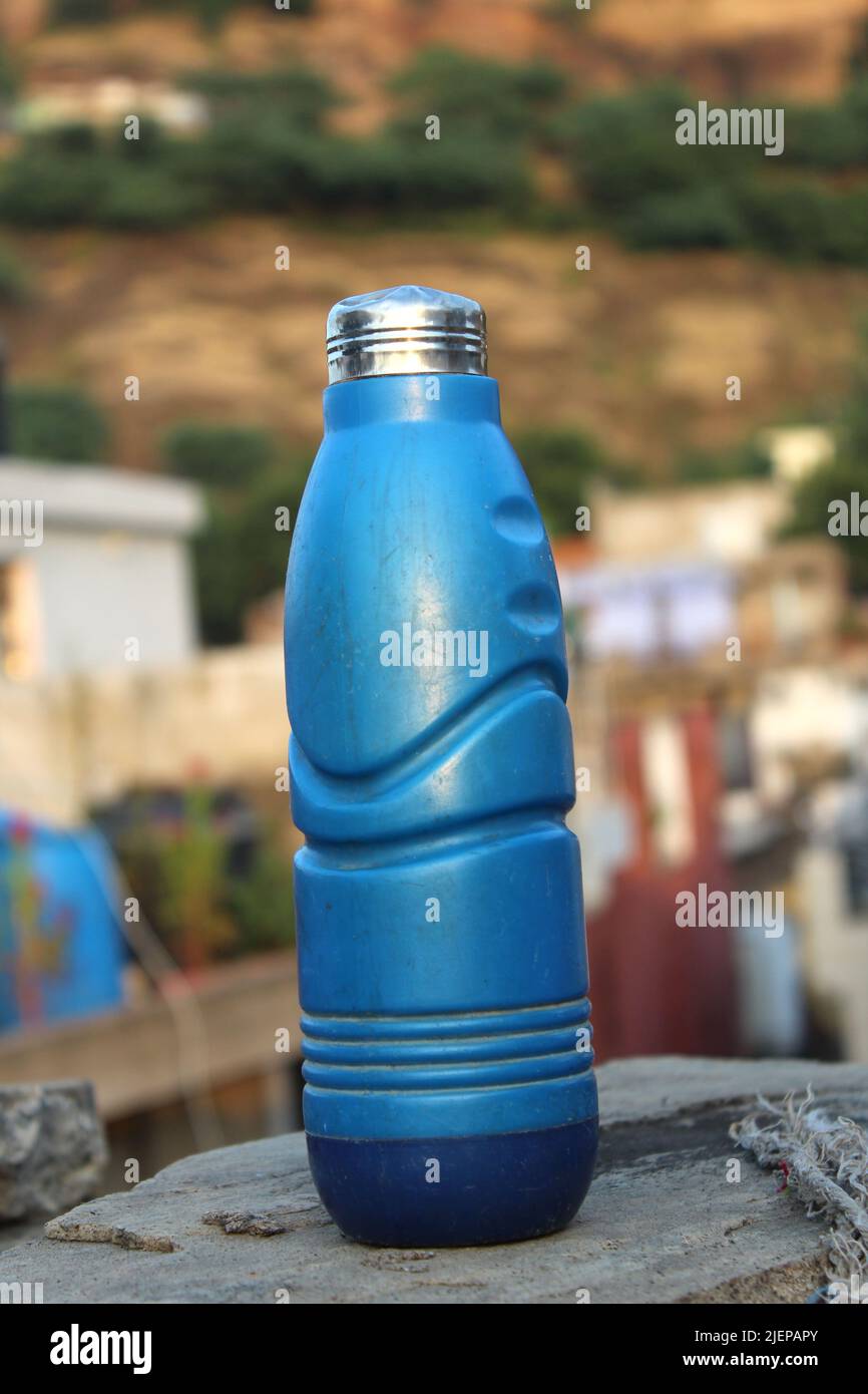 blue color plastic bottle put a stone Stock Photo - Alamy