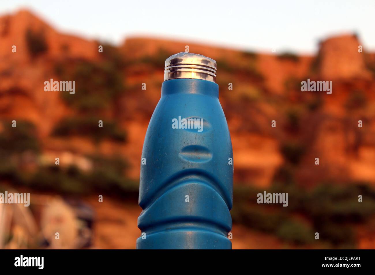 blue color plastic bottle put a stone Stock Photo - Alamy