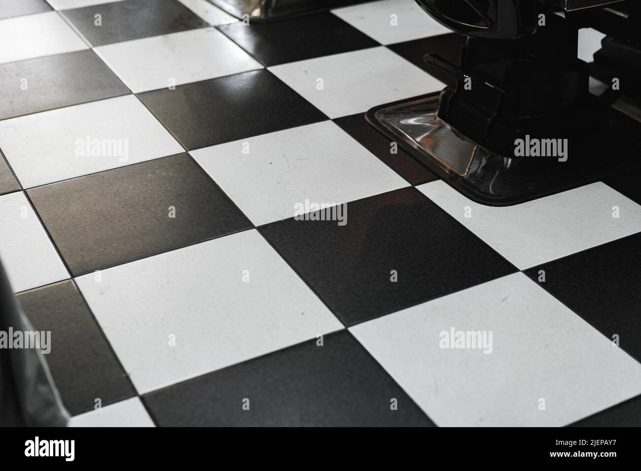 Black and white square floor interior in barbershop Stock Photo - Alamy
