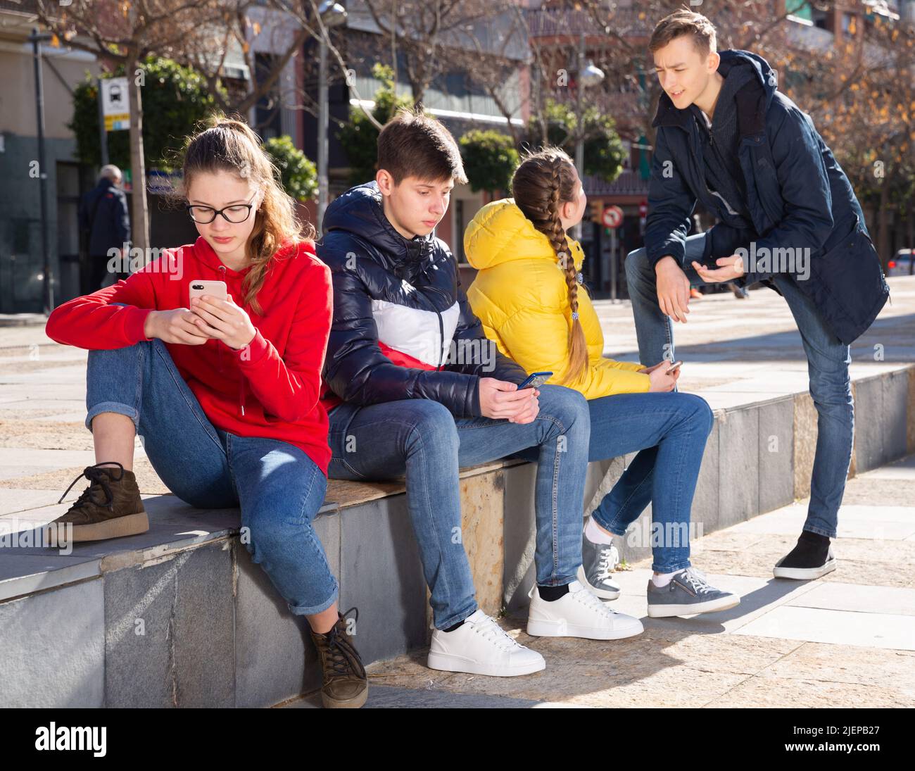 Teenagers chatting on their smartphone on walking Stock Photo - Alamy
