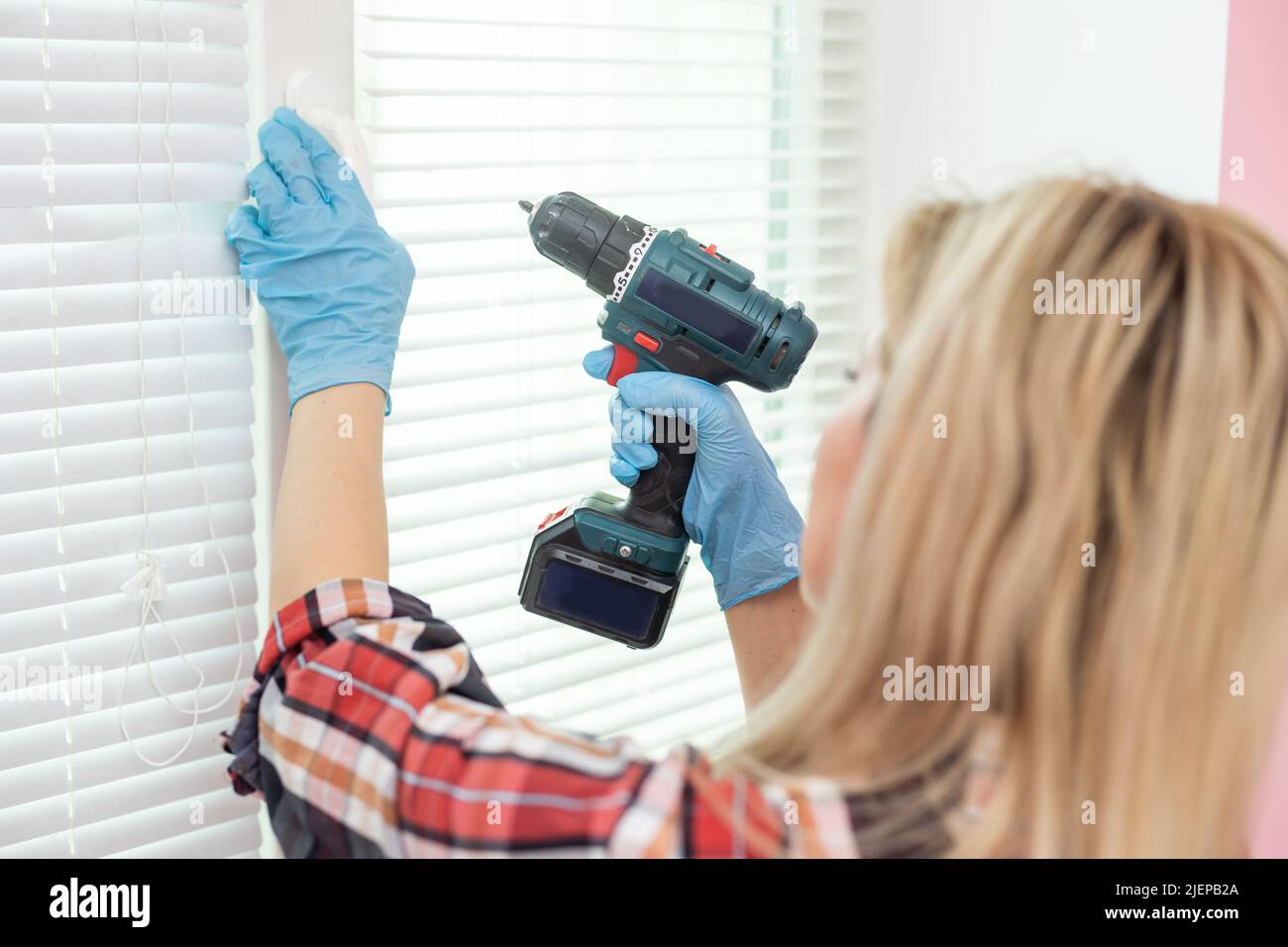 Cheerful young woman with a screwdriver Stock Photo - Alamy