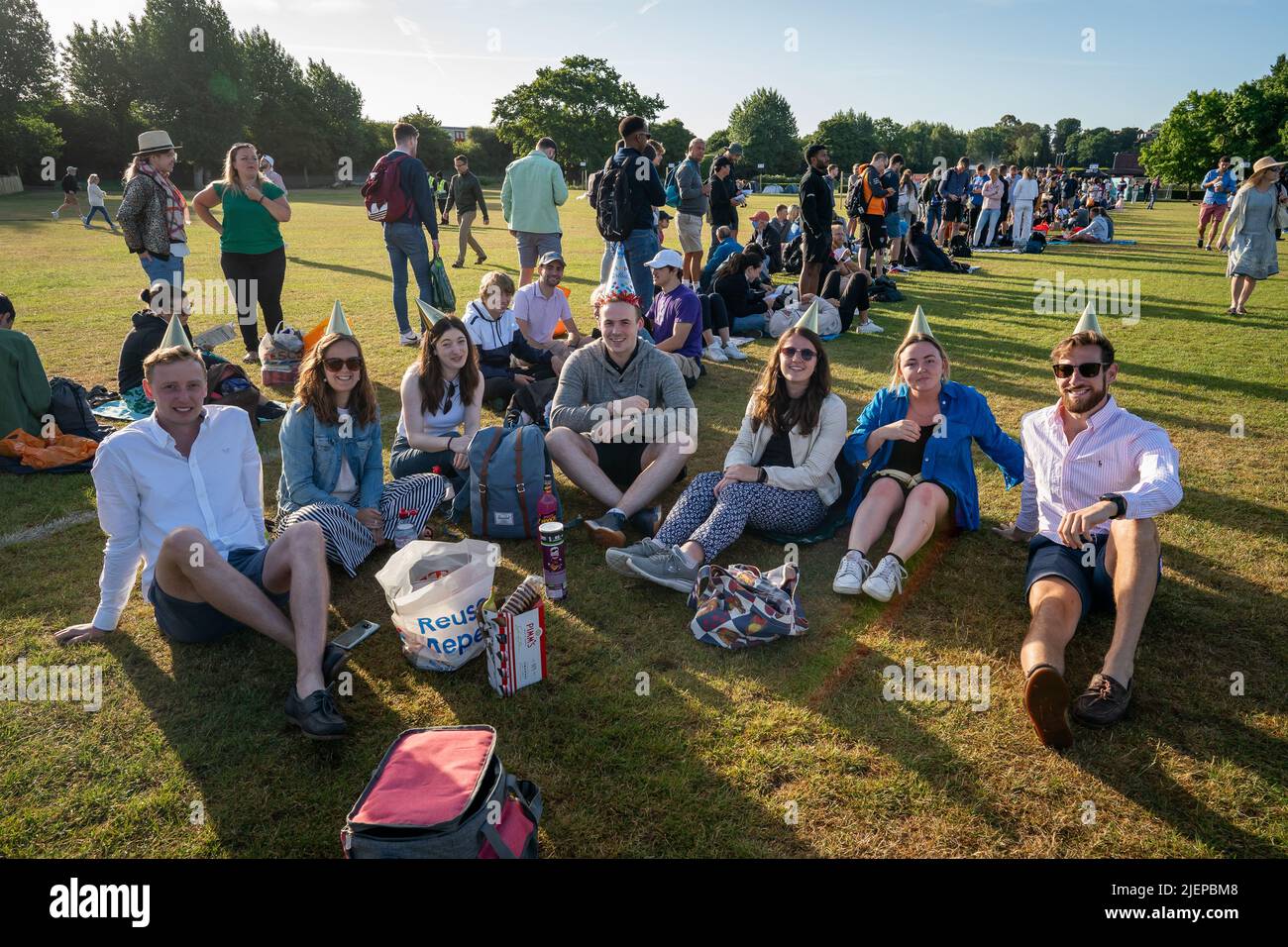 A group of friends celebrating a birthday as they wait in line to enter ...