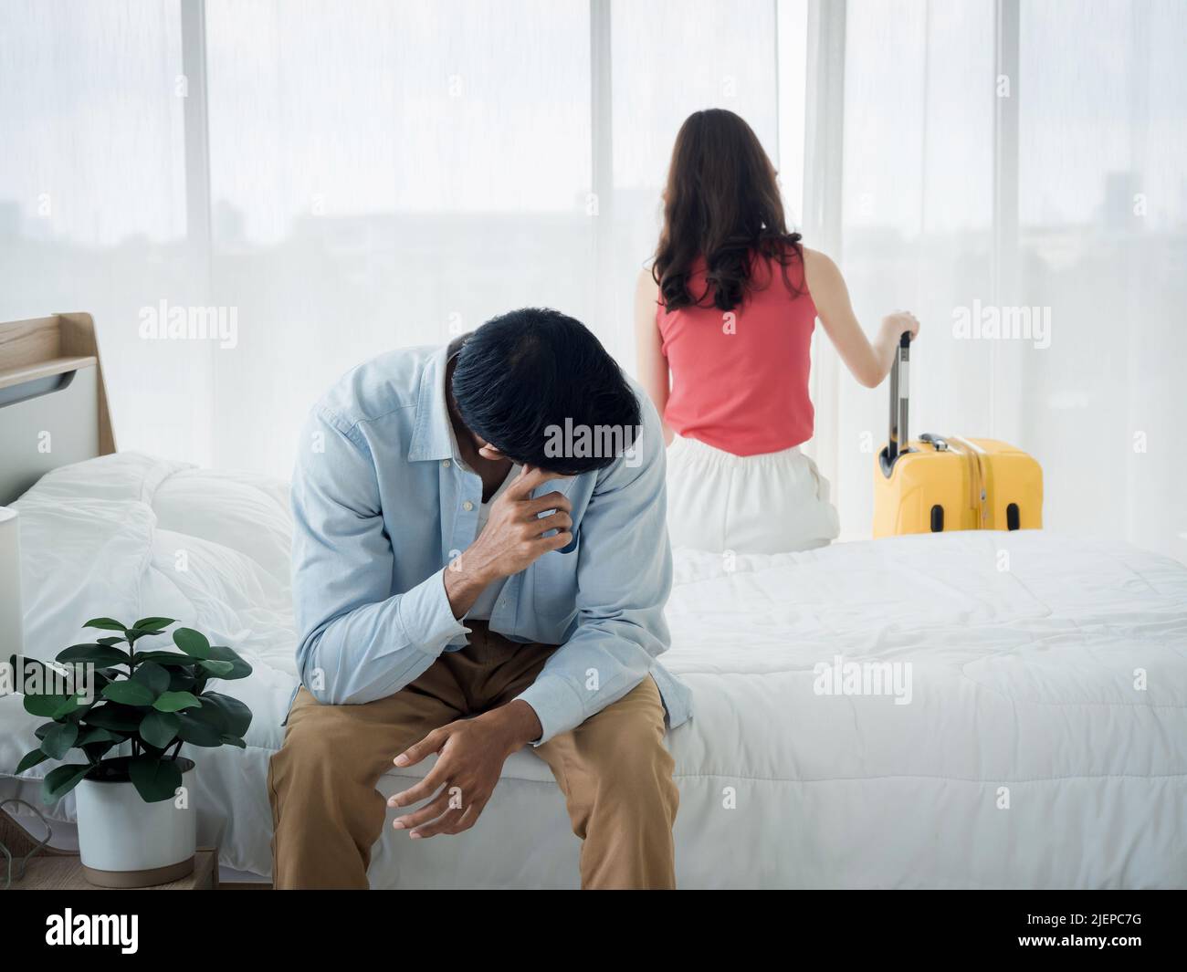 The anxiety of Asian couple lovers on the bed. Stressed man and young ...