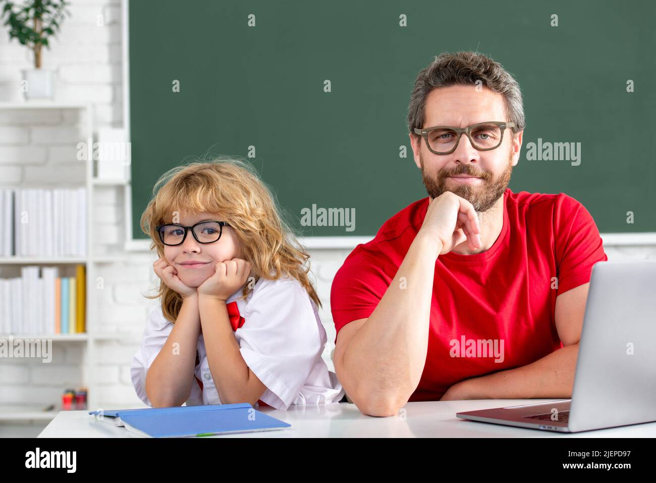 Teacher and child learning at school classroom. Education and knowledge ...