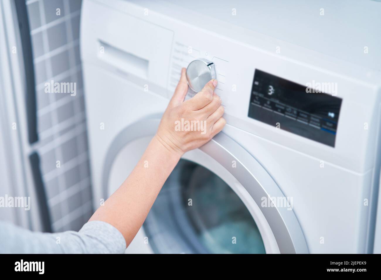 Picture of young woman making laundry work Stock Photo - Alamy