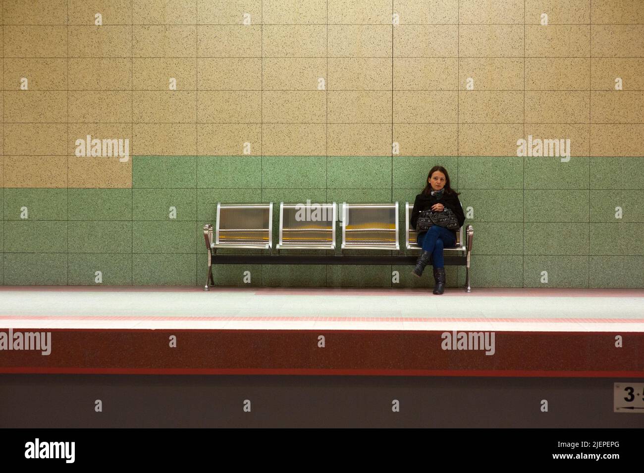 Sofia, Bulgaria. A female commuter and traveller waiting at the Capital ...