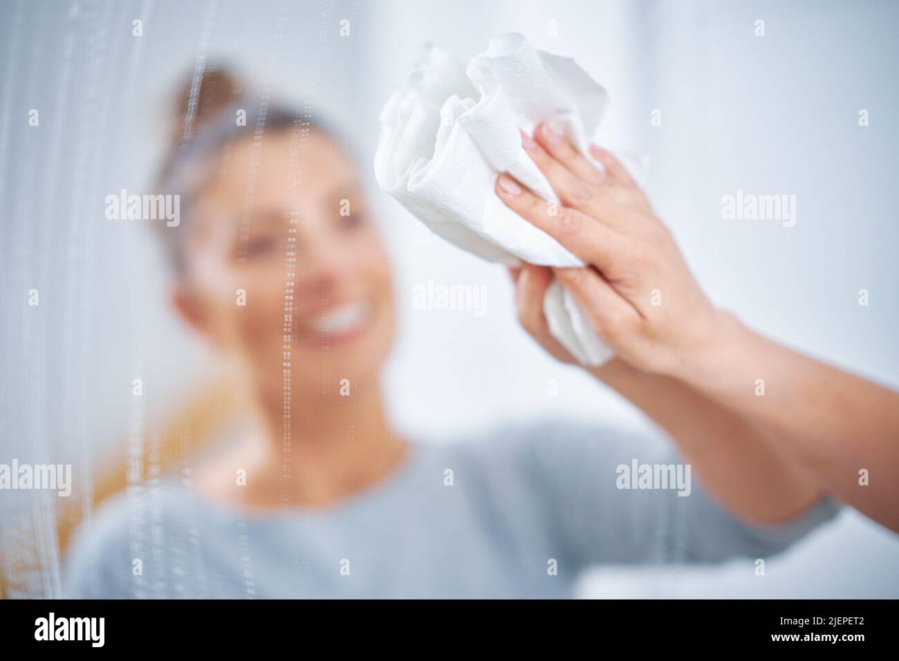Picture of yound woman cleaning mirror window Stock Photo - Alamy