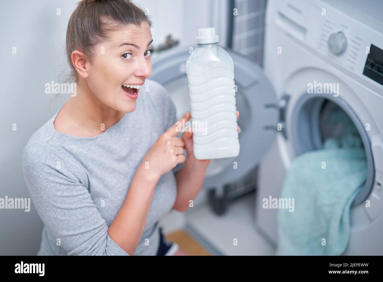 Picture of young woman making laundry work Stock Photo - Alamy
