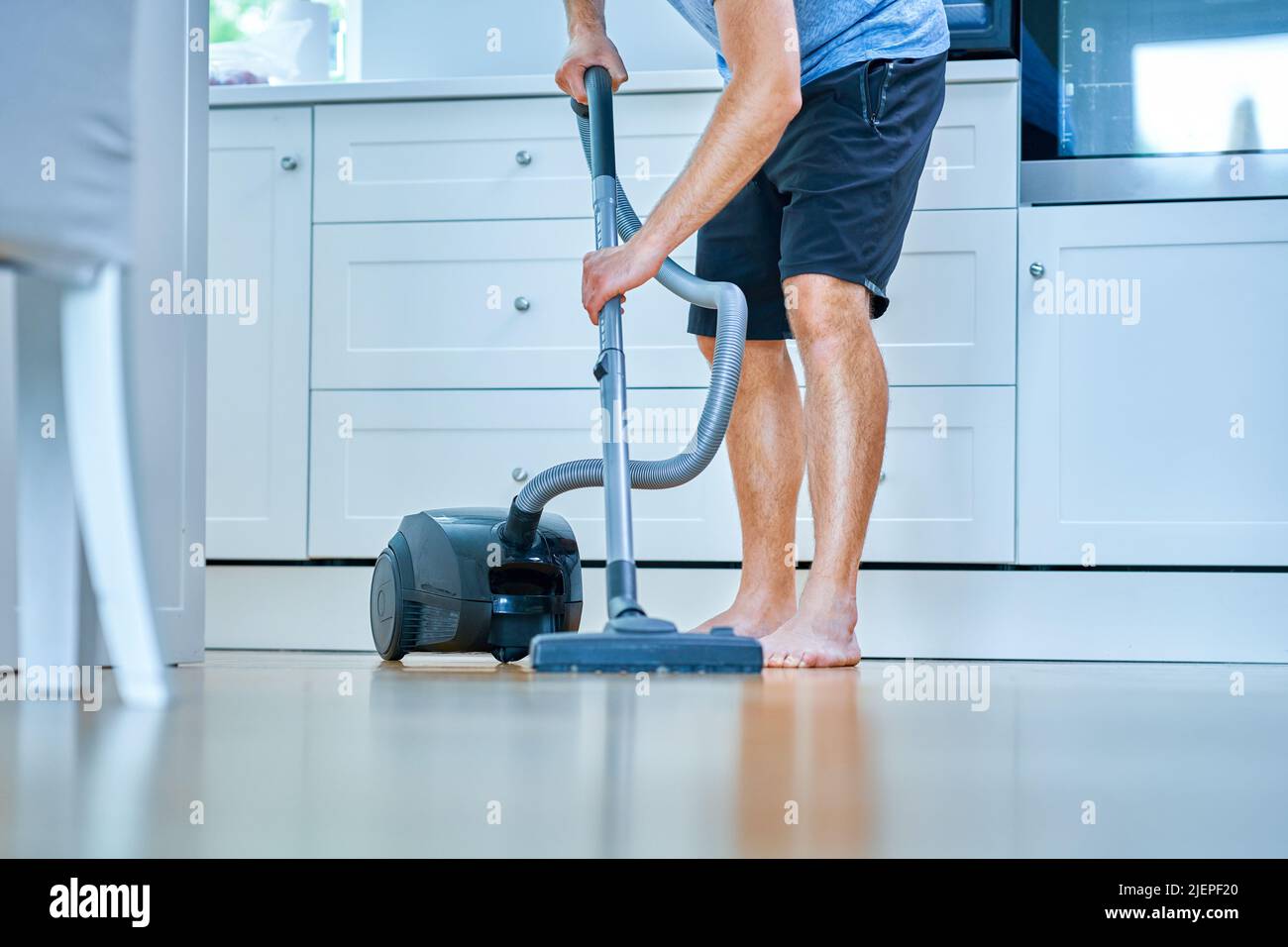 Picture of woman cleaning house using vacuum Stock Photo - Alamy