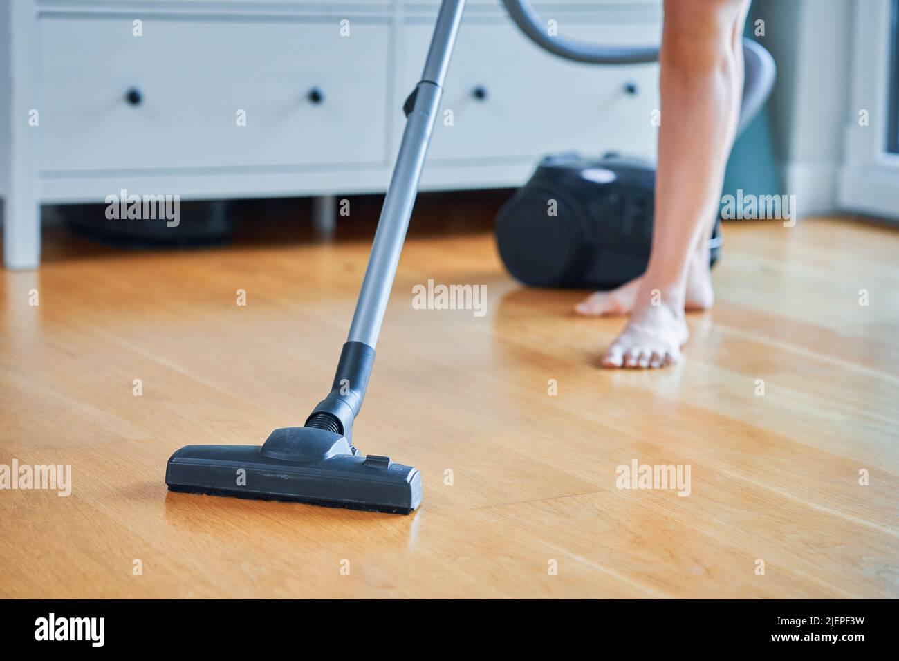 Picture of woman cleaning house using vacuum Stock Photo - Alamy