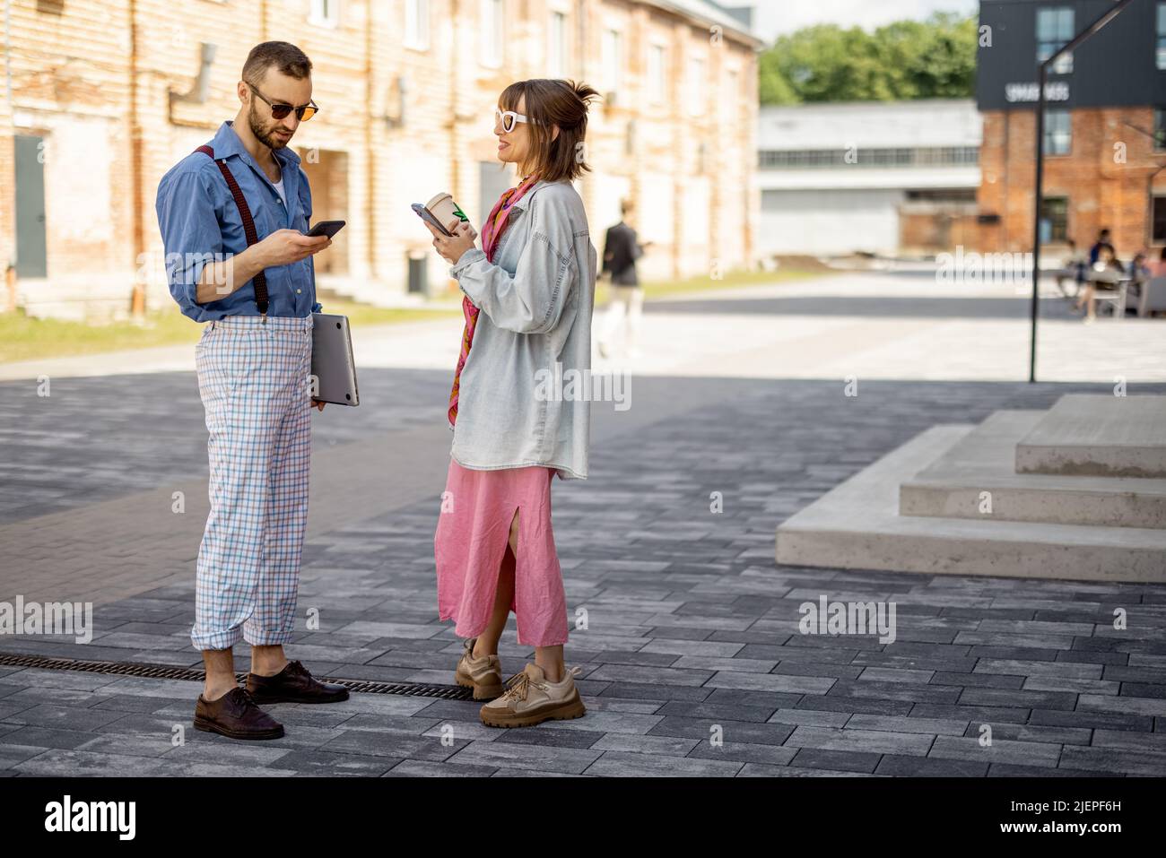 Young hipsters hang out together near office outdoors Stock Photo - Alamy
