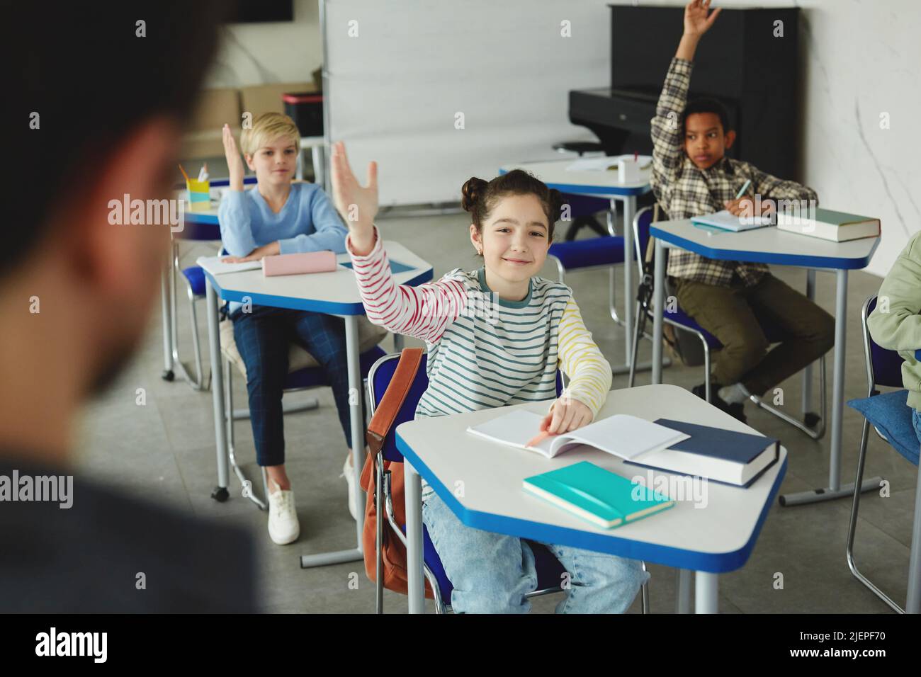 Girl raise hand classroom hi-res stock photography and images - Alamy