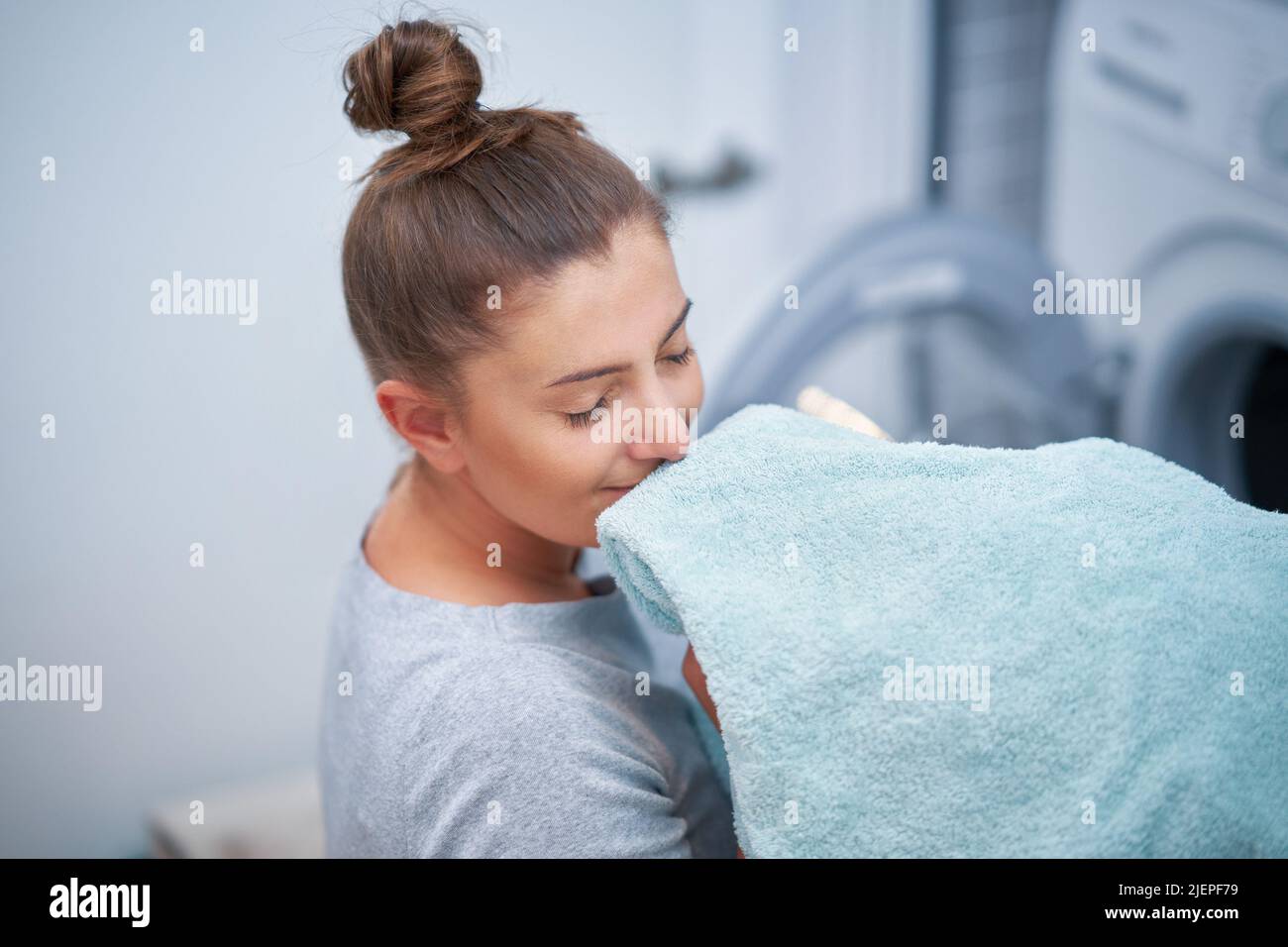 Picture of young woman making laundry work Stock Photo - Alamy