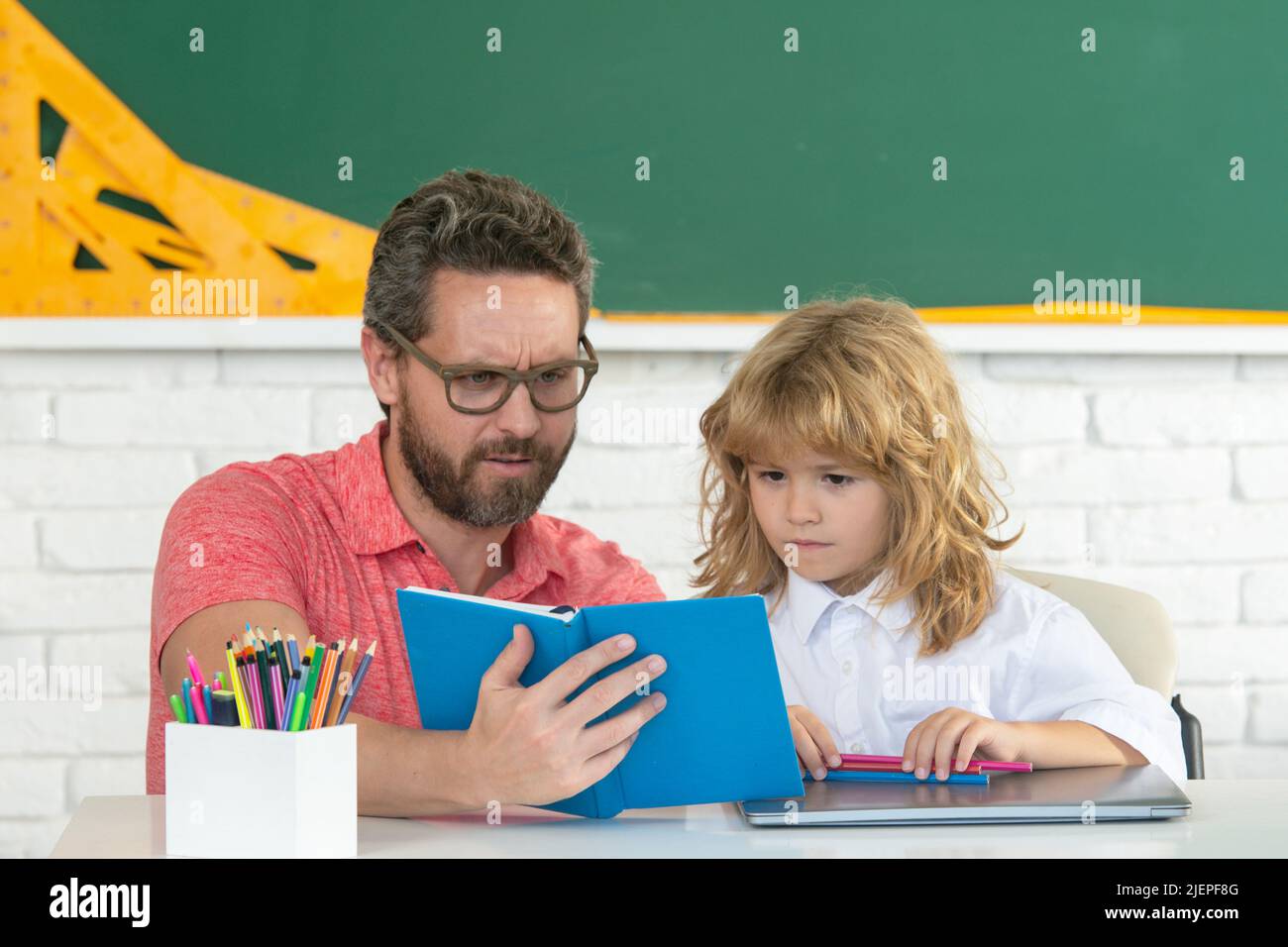 Kid boy learning with teacher. Funny little boy study with father in ...