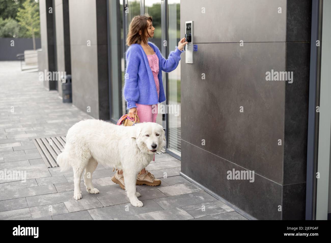 Young stylish woman getting access to the building by attaching ...