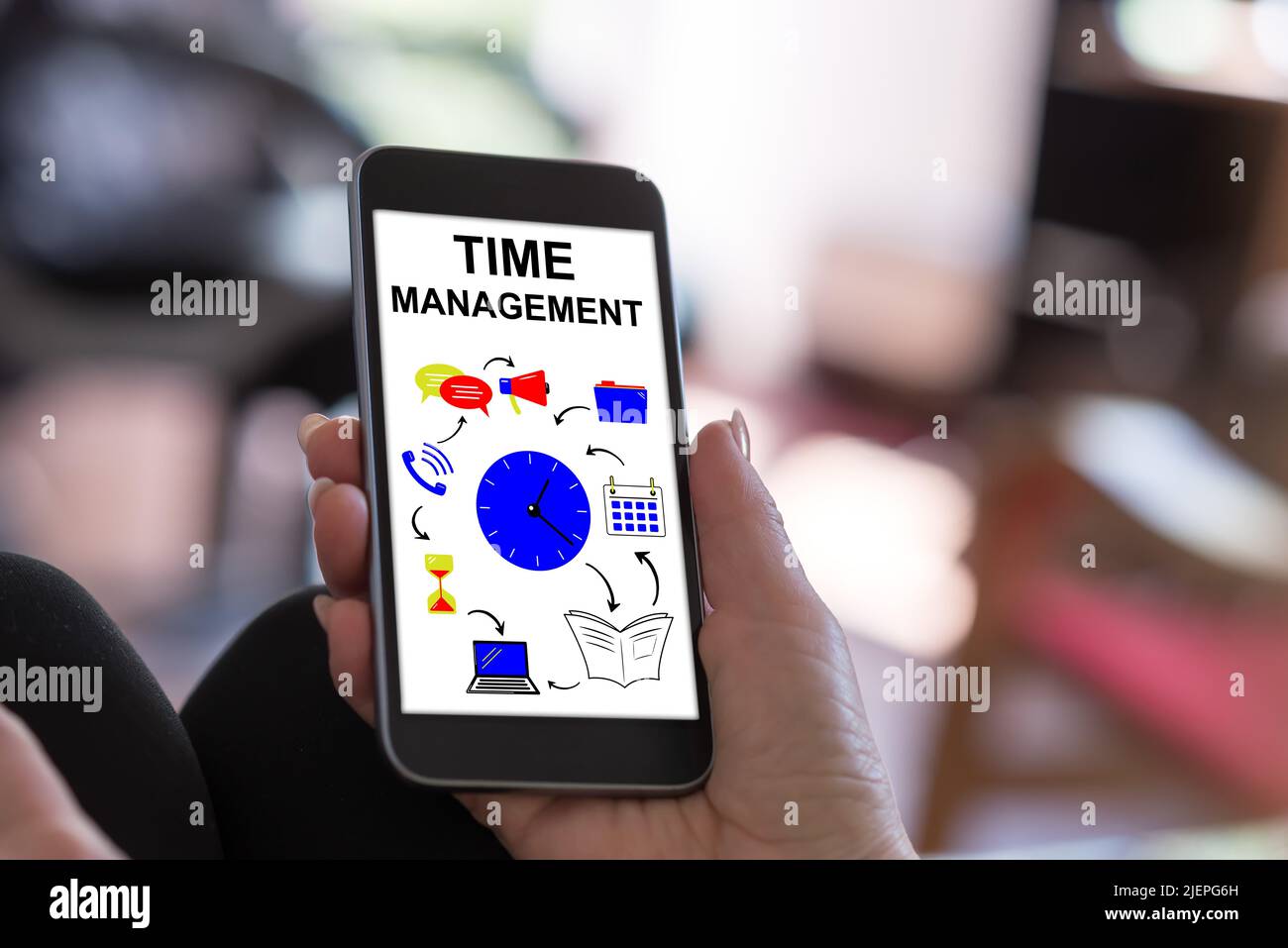 Hand holding a smartphone with time management concept Stock Photo - Alamy