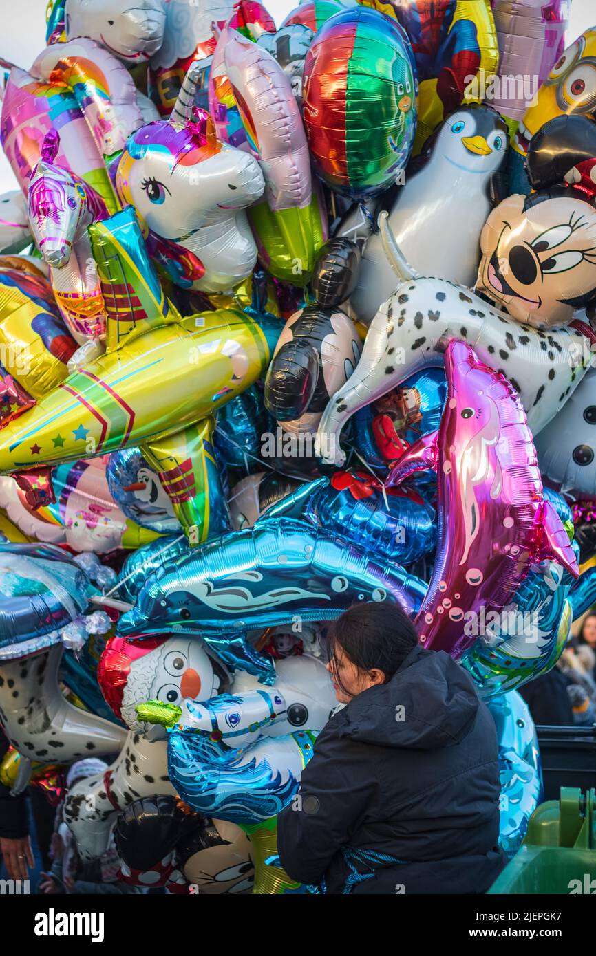 London, UK - 2 December, 2021 - Female street vendor sells multiple ...