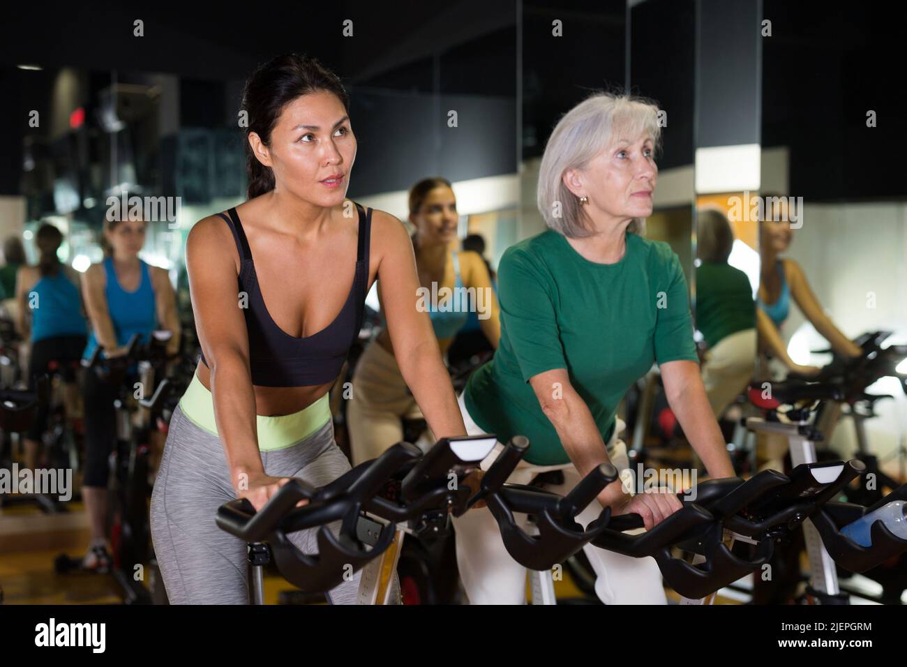 Two woman at group training on fitness bikes Stock Photo - Alamy