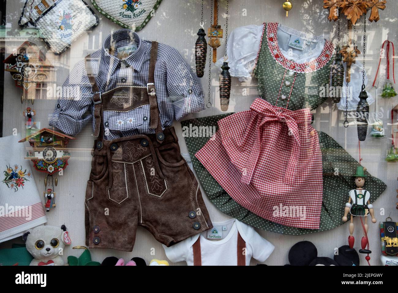 Gift shop window display of traditional Austrian outfits of a girl and ...
