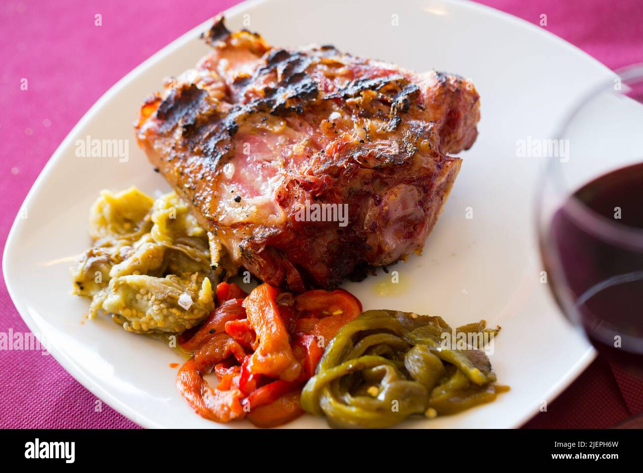 Broiled pork knuckle with vegetable garnish Stock Photo - Alamy