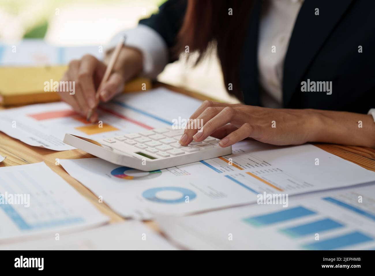 Close up Business woman hand using calculator to calculate the company ...