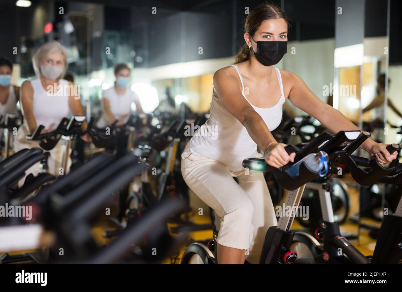 Woman taking indoor cycling class at gym Stock Photo - Alamy